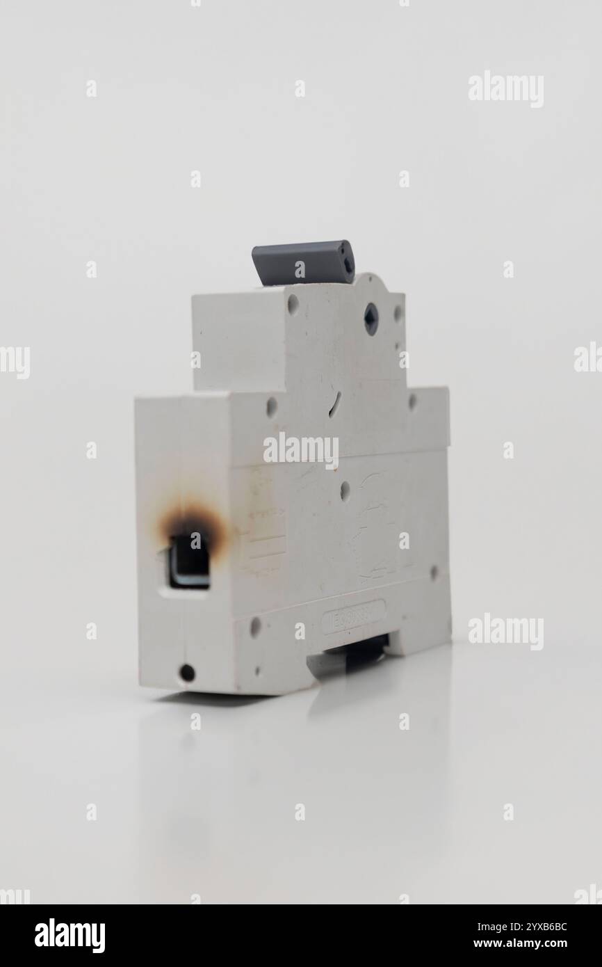 White circuit breaker damaged by burning and overheating, indicating ...