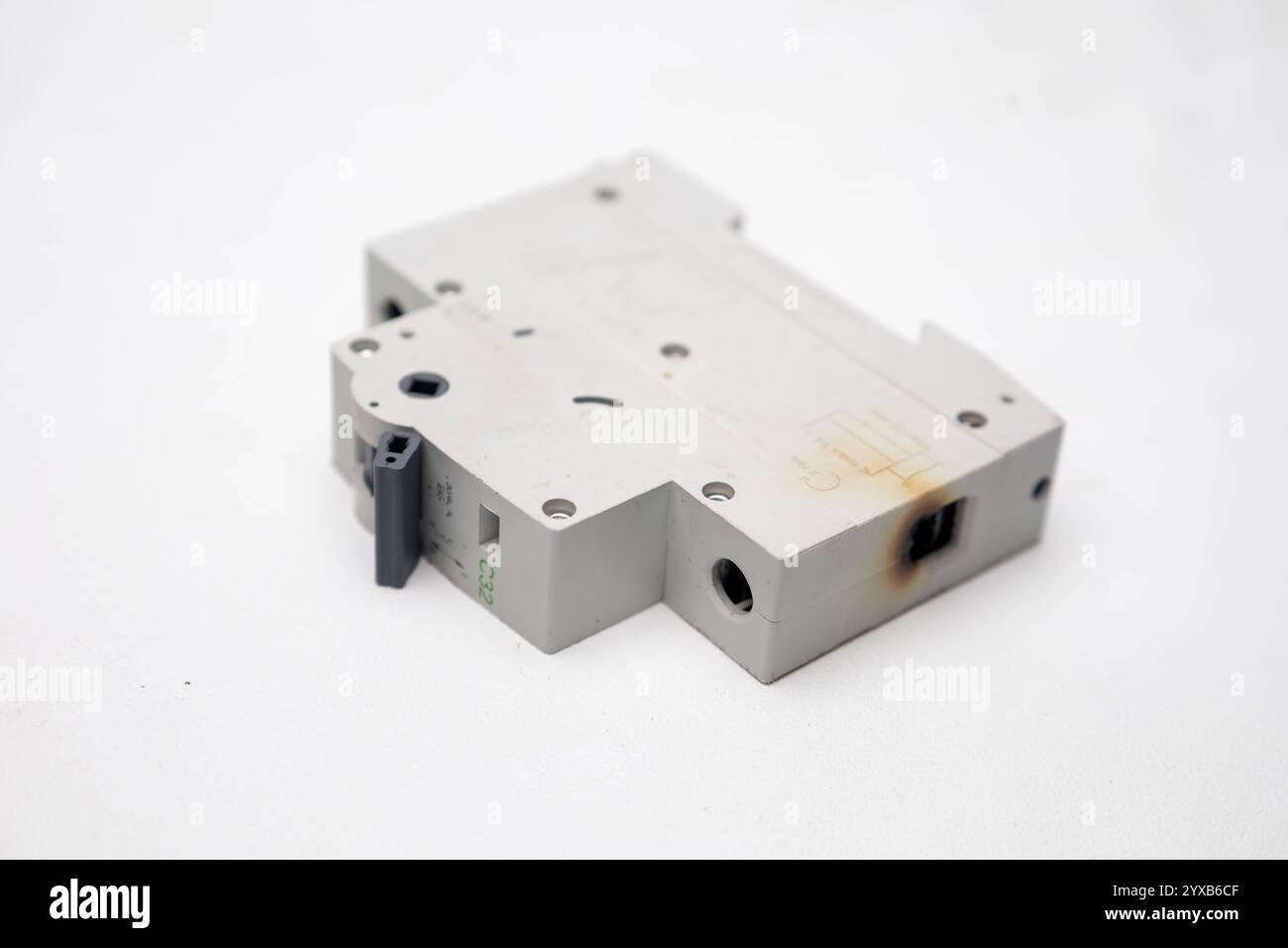 Damaged circuit breaker isolated on white background, highlighting ...