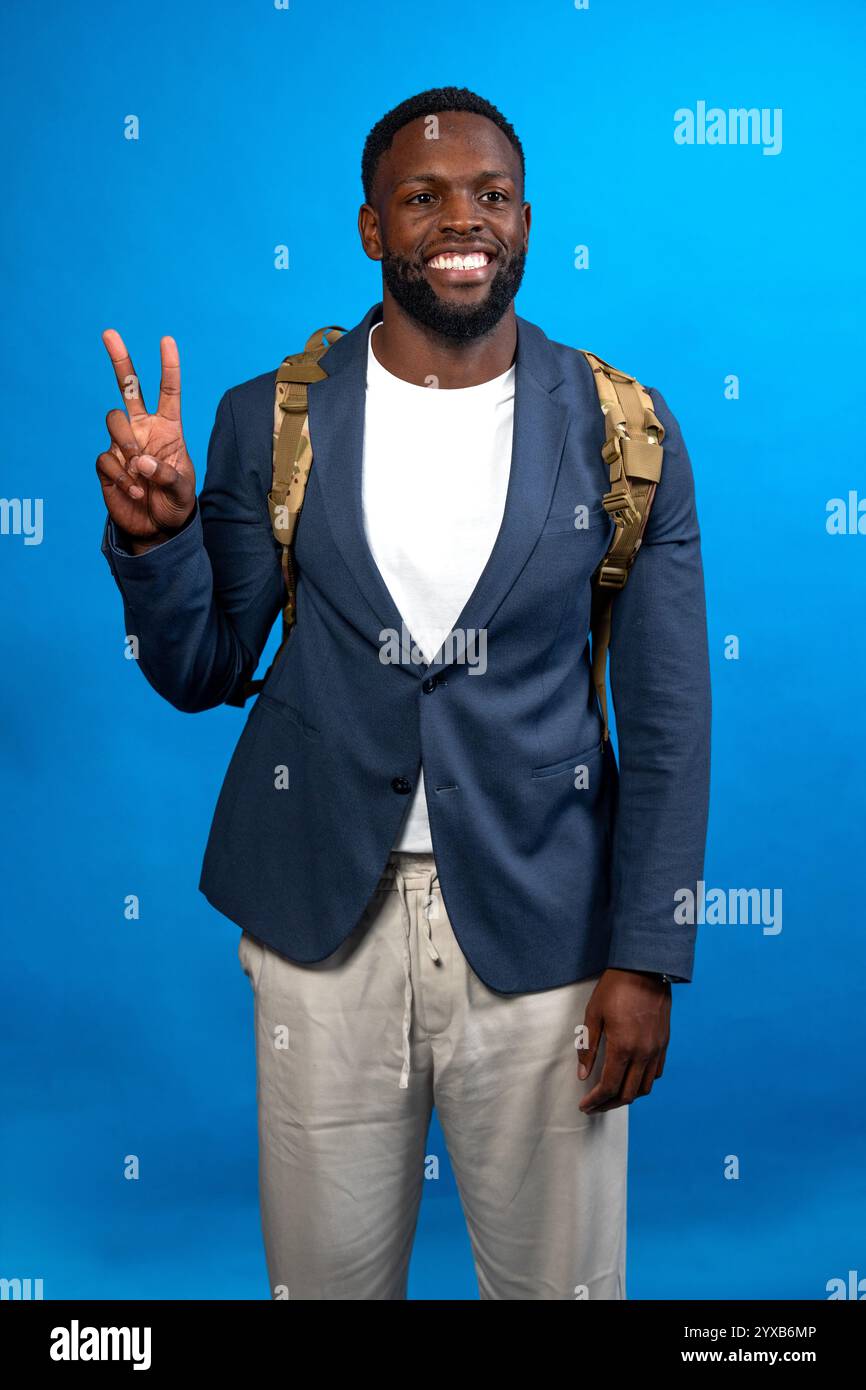 Young black entrepreneur showing two fingers up wearing suit and ...