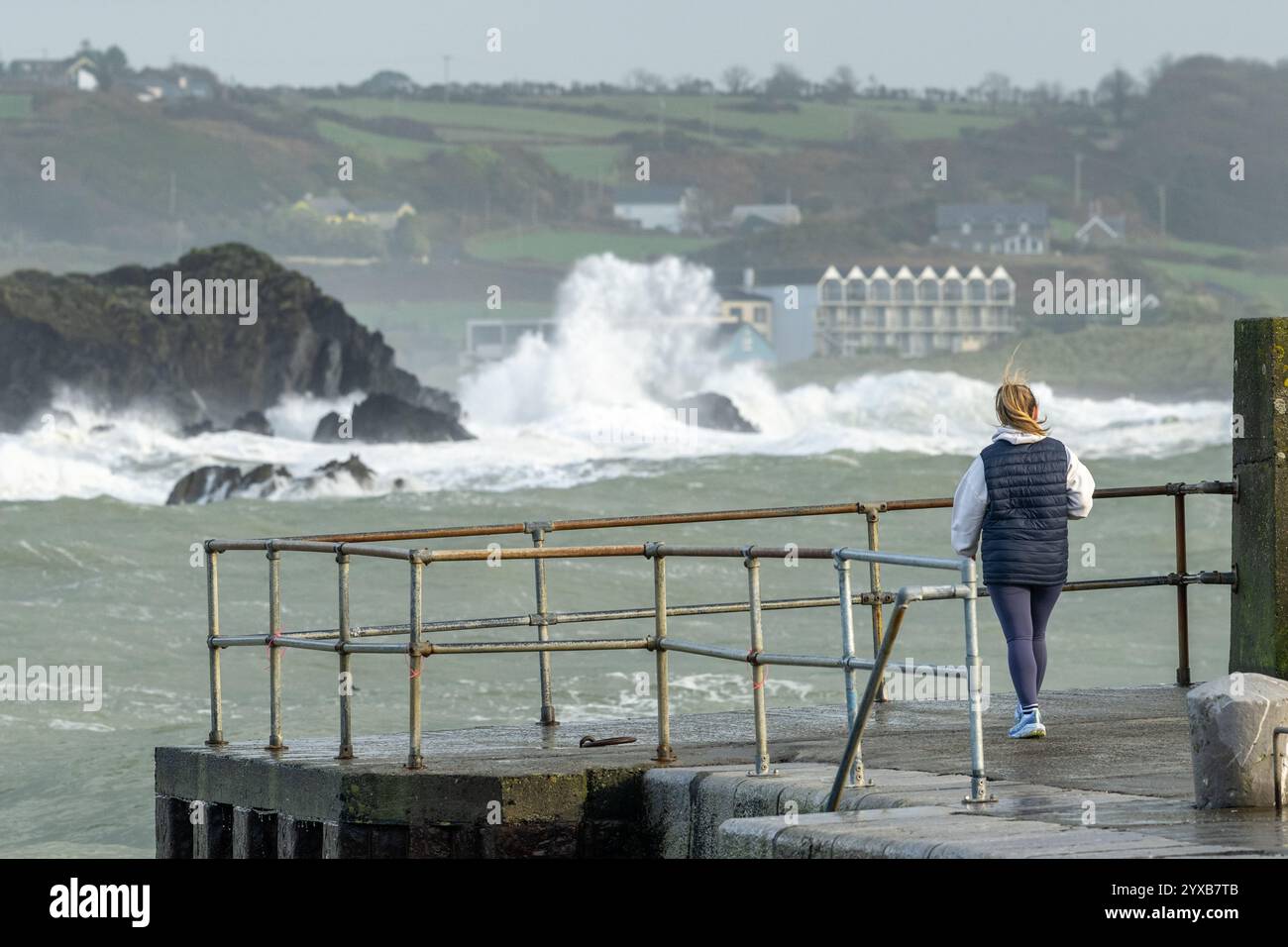 Woman watching huge waves hit rocks during Storm Bert in Rosscarbery ...