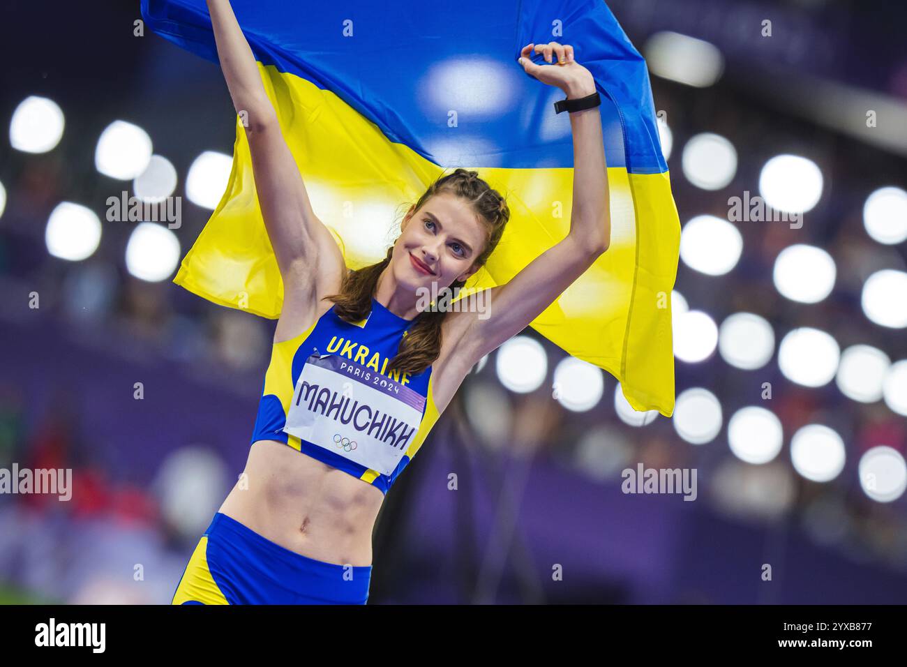 Yaroslava Mahuchikh celebrating her medal with her country's flag at ...