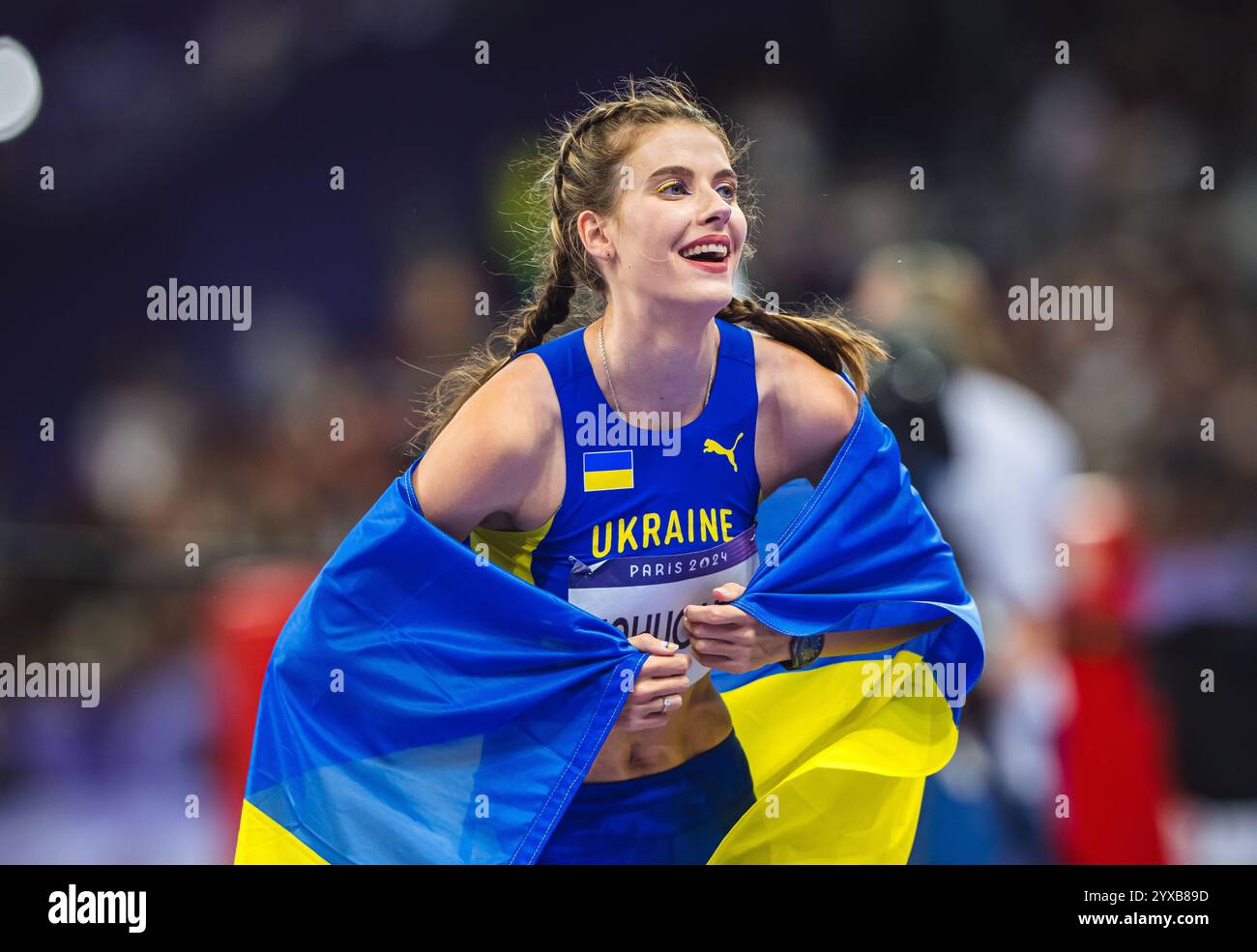 Yaroslava Mahuchikh celebrating her medal with her country's flag at ...