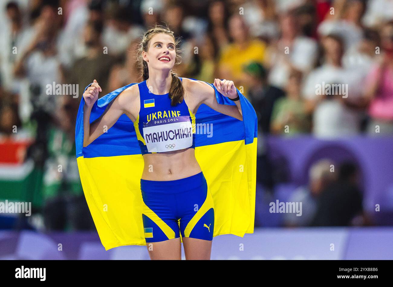 Yaroslava Mahuchikh celebrating her medal with her country's flag at ...