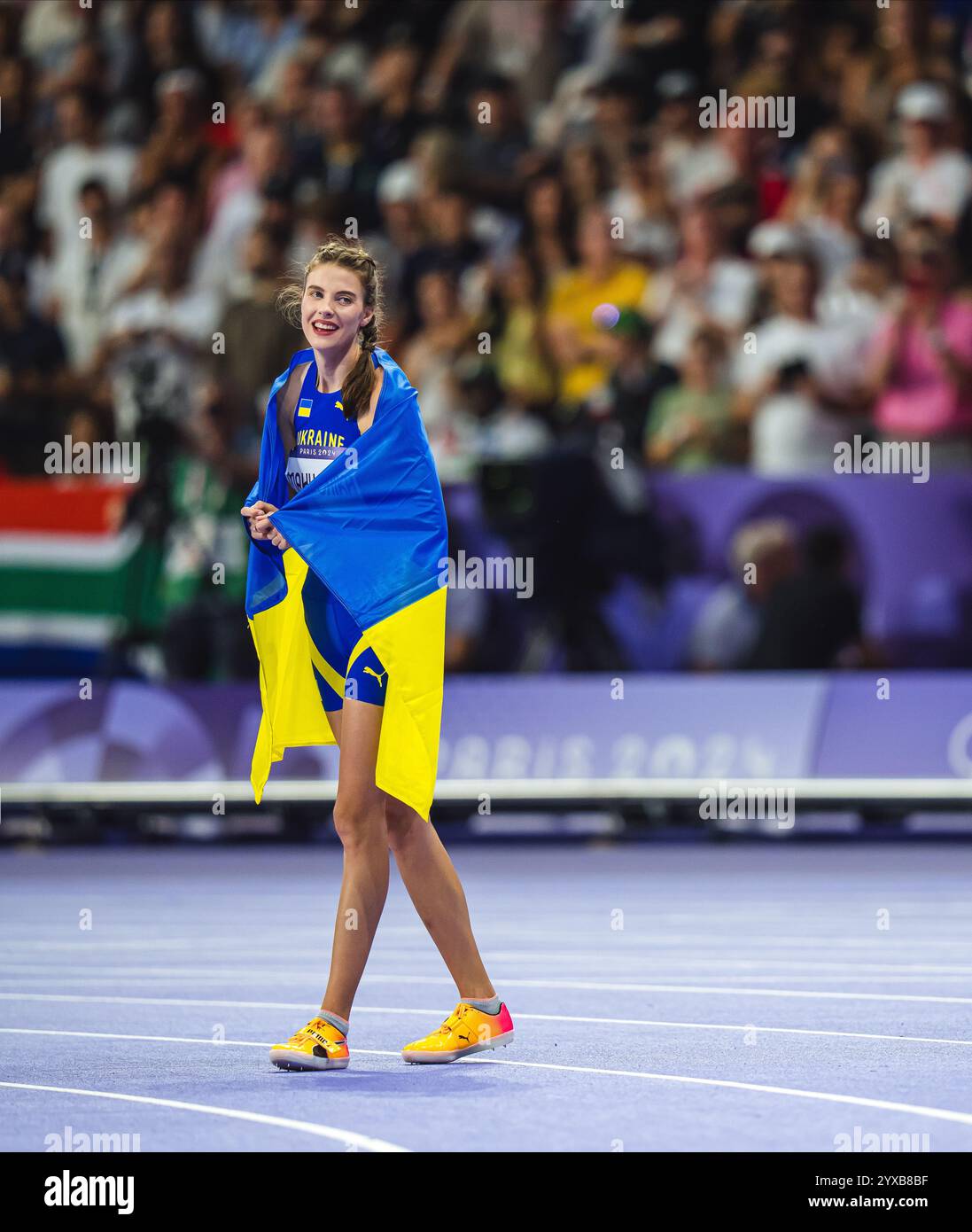 Yaroslava Mahuchikh celebrating her medal with her country's flag at ...