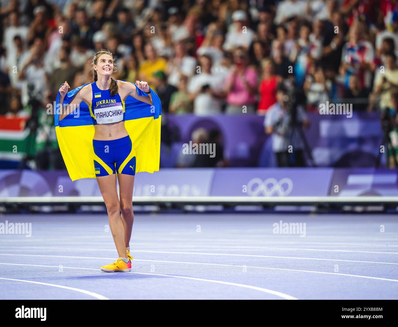 Yaroslava Mahuchikh celebrating her medal with her country's flag at ...