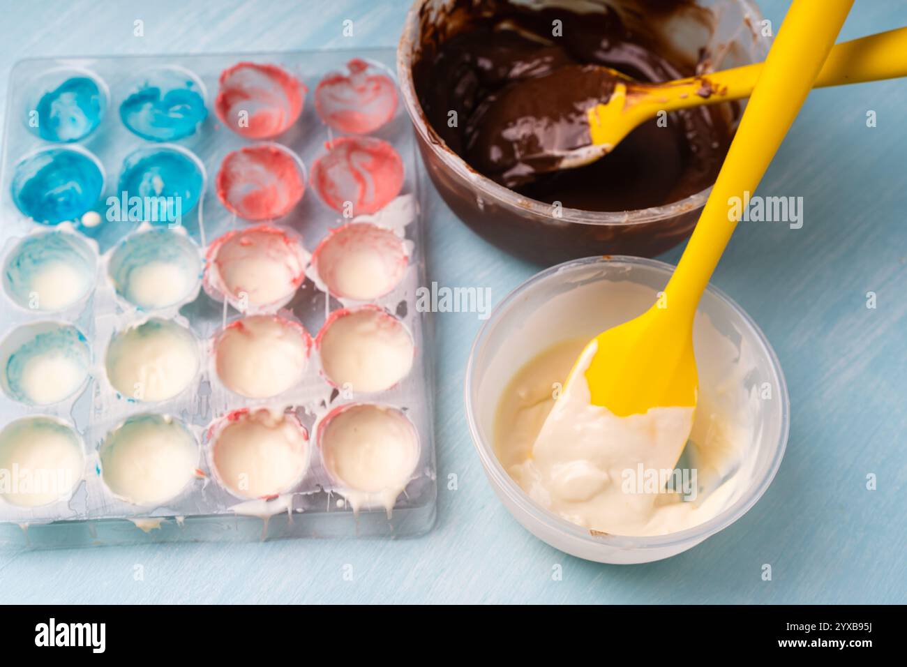 The process of making handmade chocolates. A candy mold with colorful ...