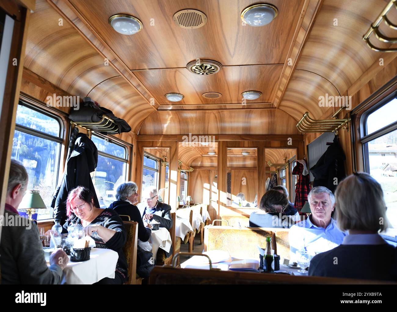Chur. 1st Dec, 2024. Passengers dine at the vintage carriage on the ...