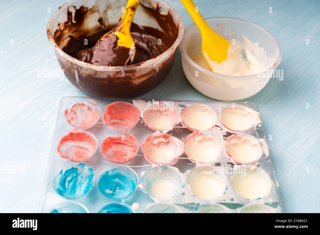 The process of making handmade chocolates. A candy mold with colorful ...