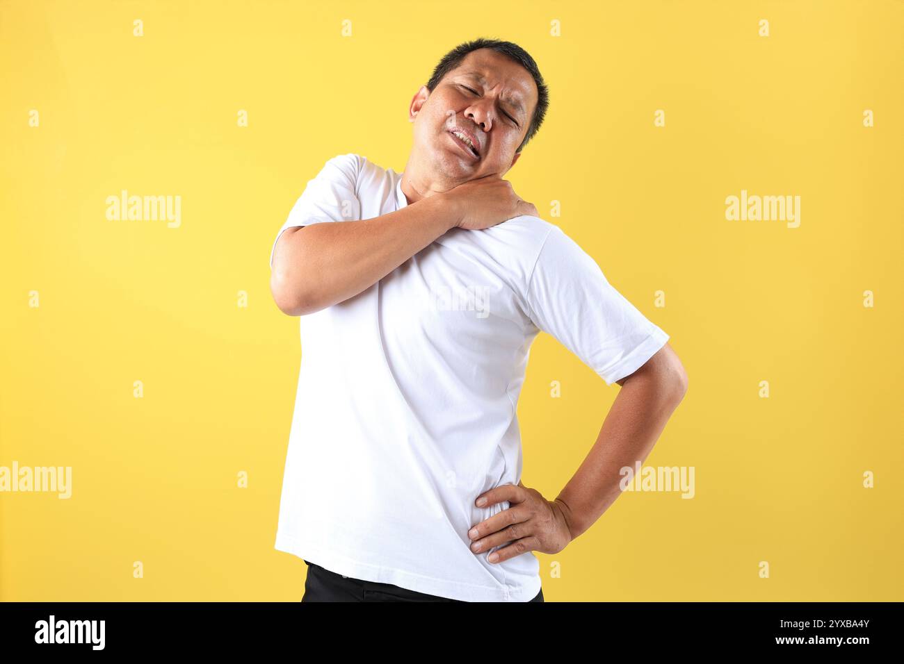 Asian Senior Man with Shoulder Pain isolated on Yellow Background ...