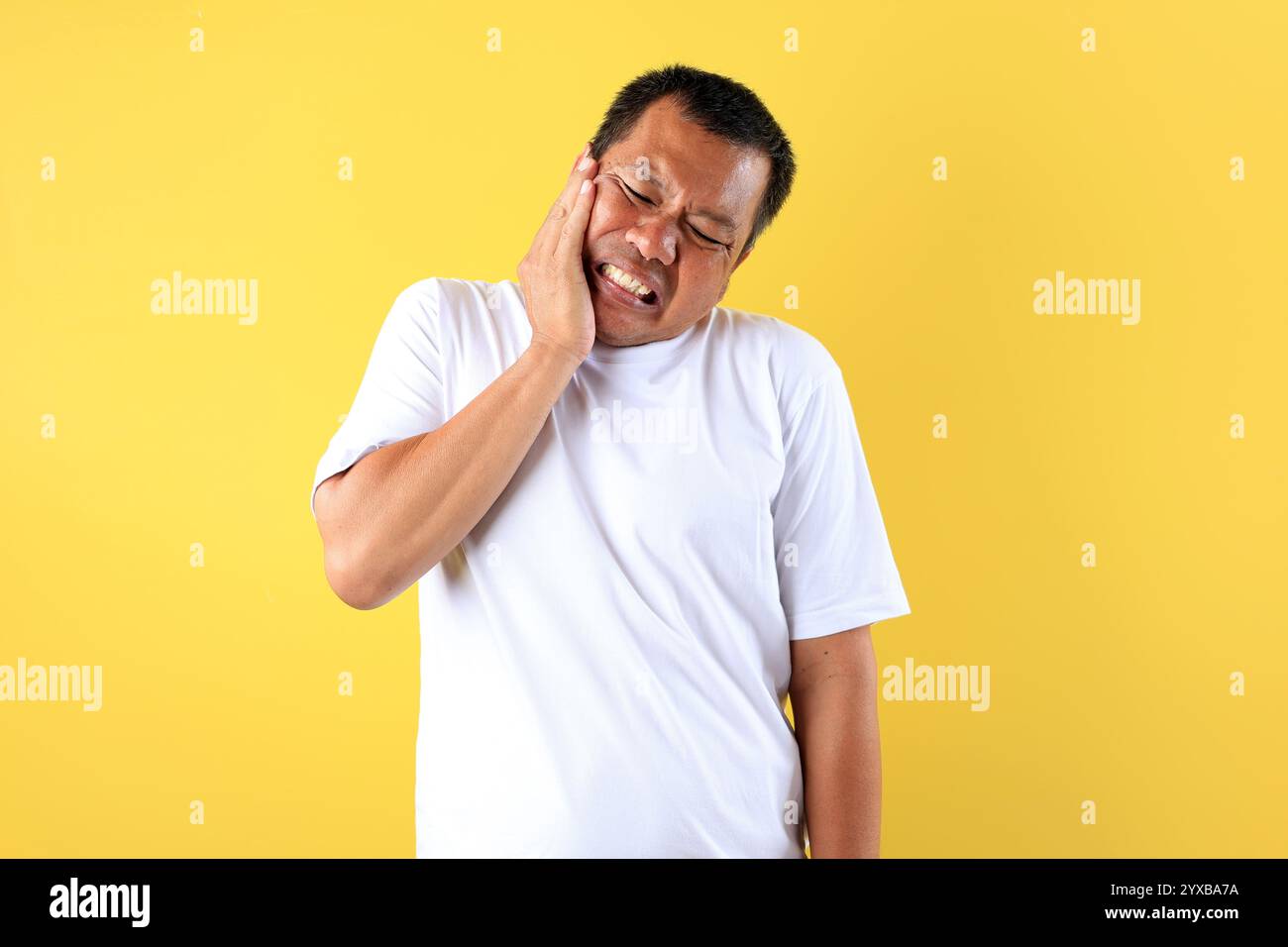 Portrait of Asian Man Wearing White T Shirt Touching His Cheek, Has ...