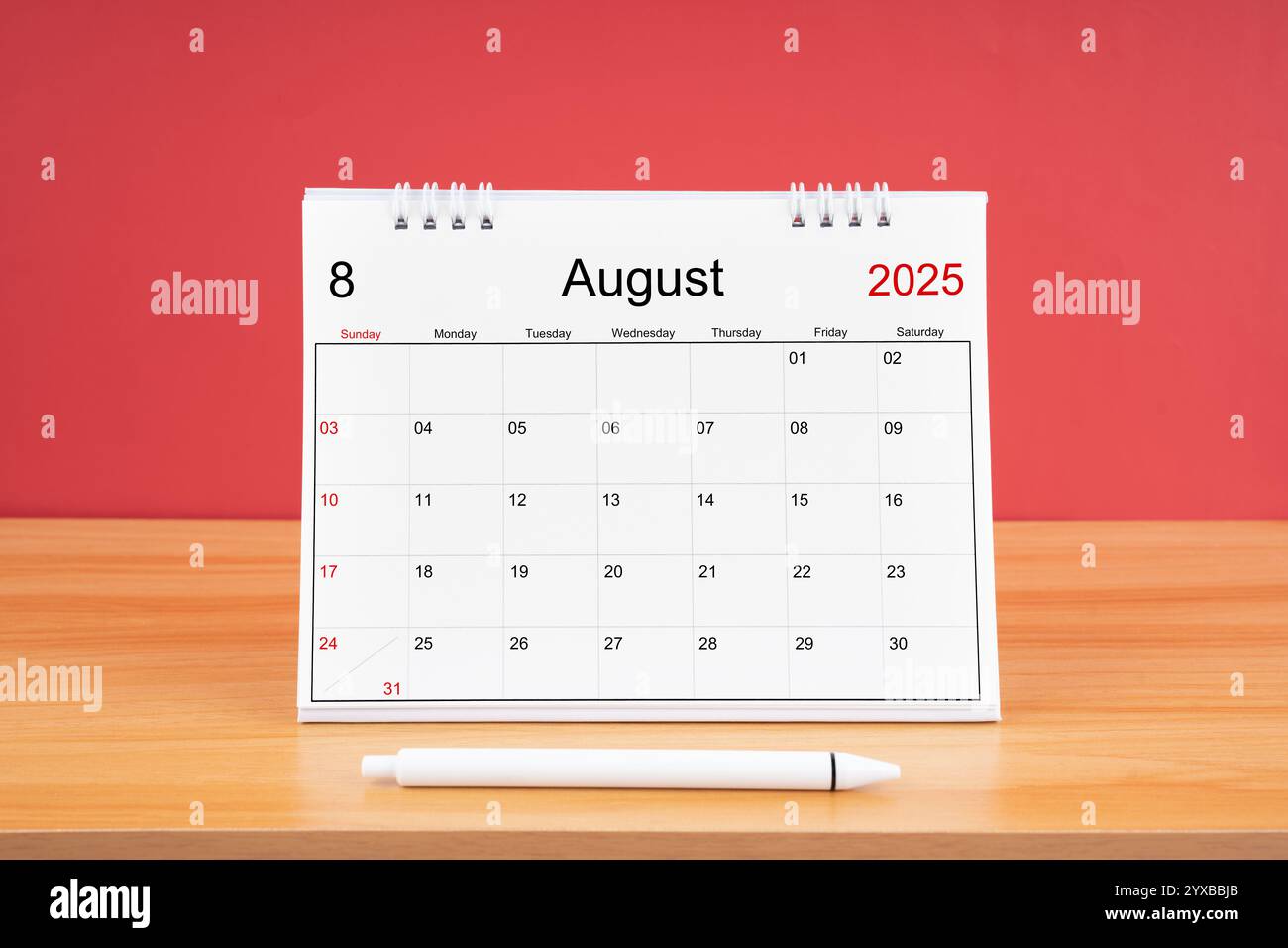 August monthly desk calendar for 2025 year and pen on the wooden table ...