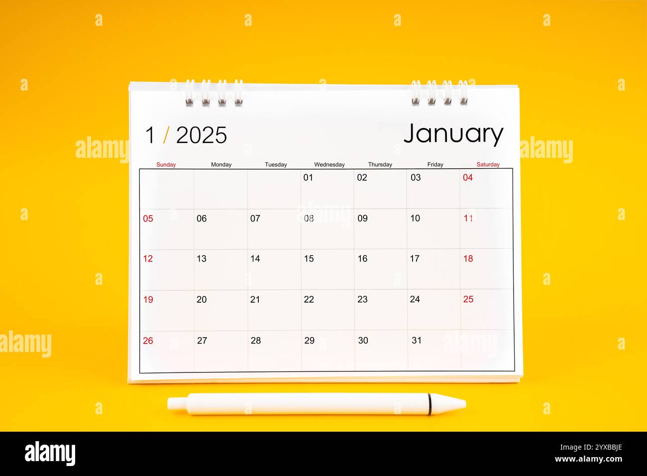 January 2025, Monthly desk calendar for 2025 year and pen on yellow ...