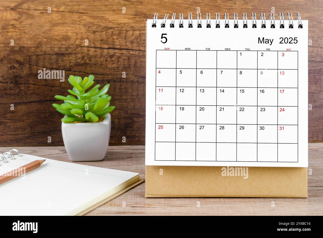 May 2025 desk calendar on wooden table Stock Photo - Alamy