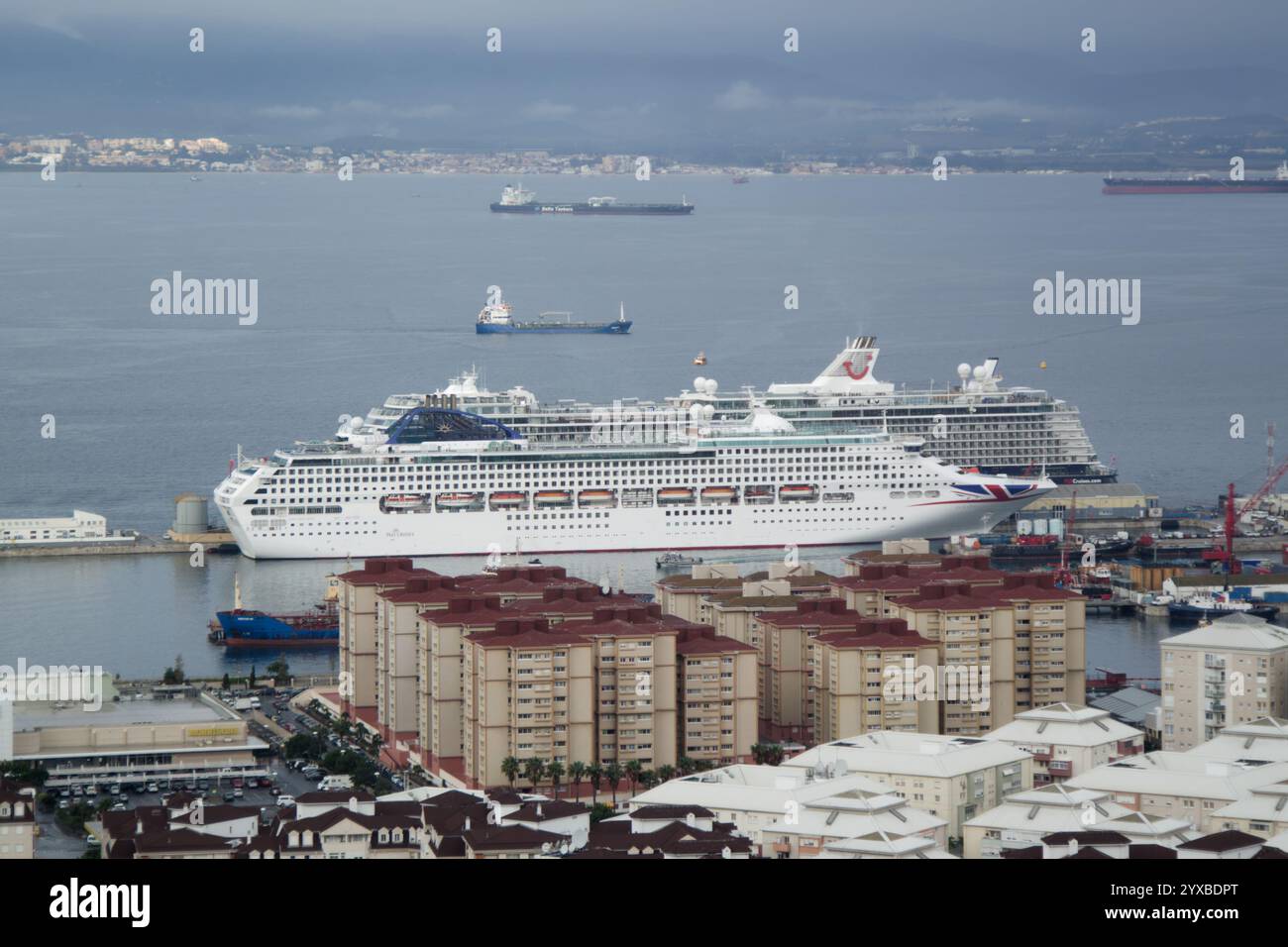 Cruise ships berthed in Gibraltar harbour, with Algeciras across the ...