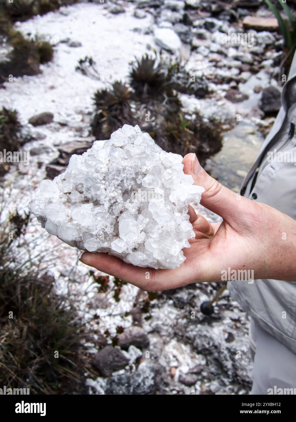 Woman's hand holding large natural crystal on plateau of Mount Roraima ...