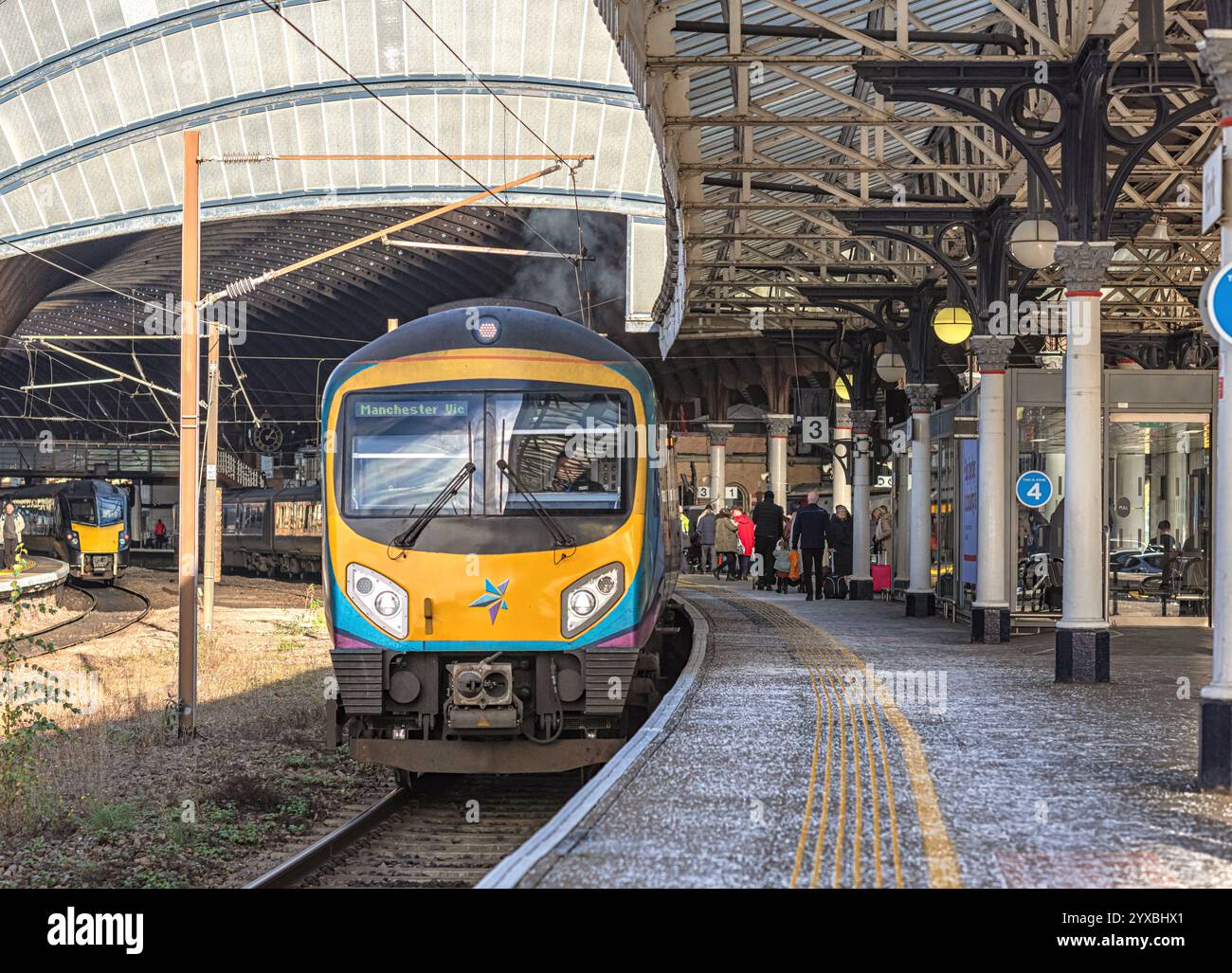 A train comes to a stop at a railway station platform. An historic iron ...