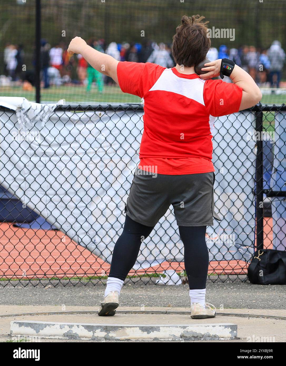 Rear view of a young athlete focuses on his technique before releasing ...