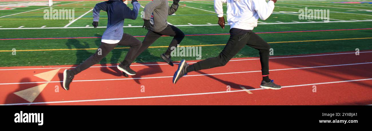 Three athletes race on a track, showcasing their speed and ...