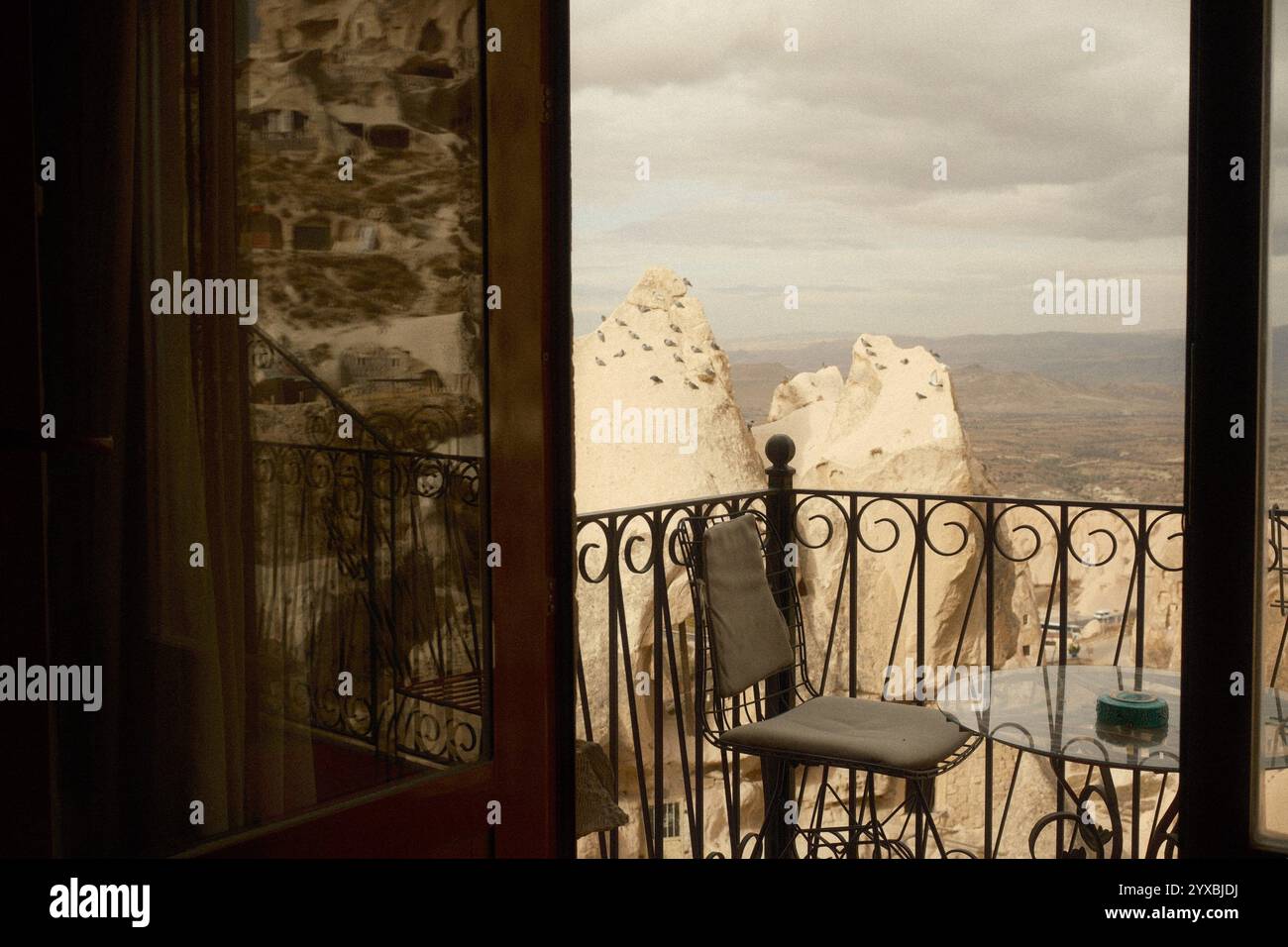 The private room balcony with an antique metal table and chairs ...