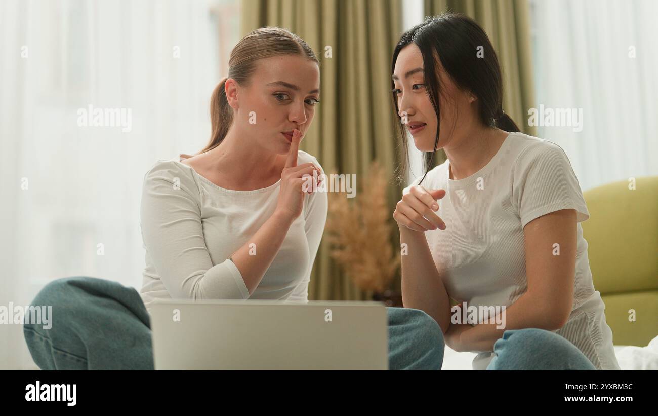 Two happy multiracial multiethnic women female people diversity girls Caucasian woman talking ...