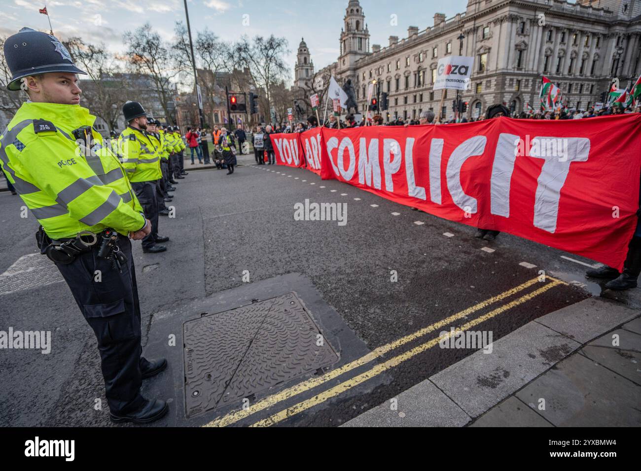 London, UK. 14th Dec, 2024. Police had to form a human cordon to ...