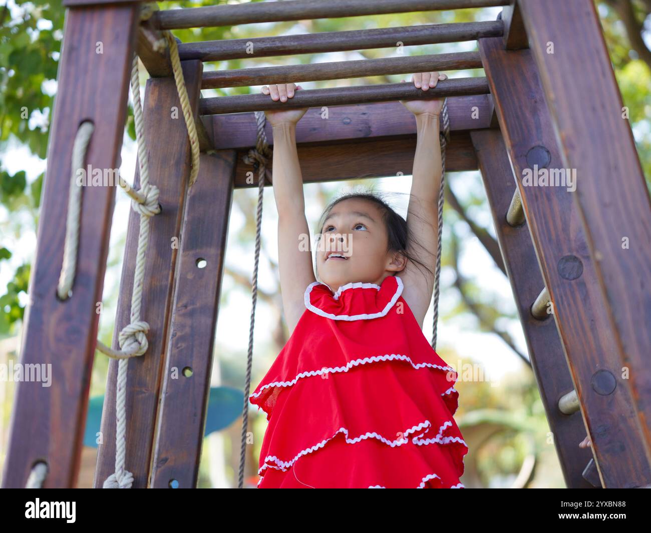 Cute girl playing in the playground during summer vacation. Happy ...