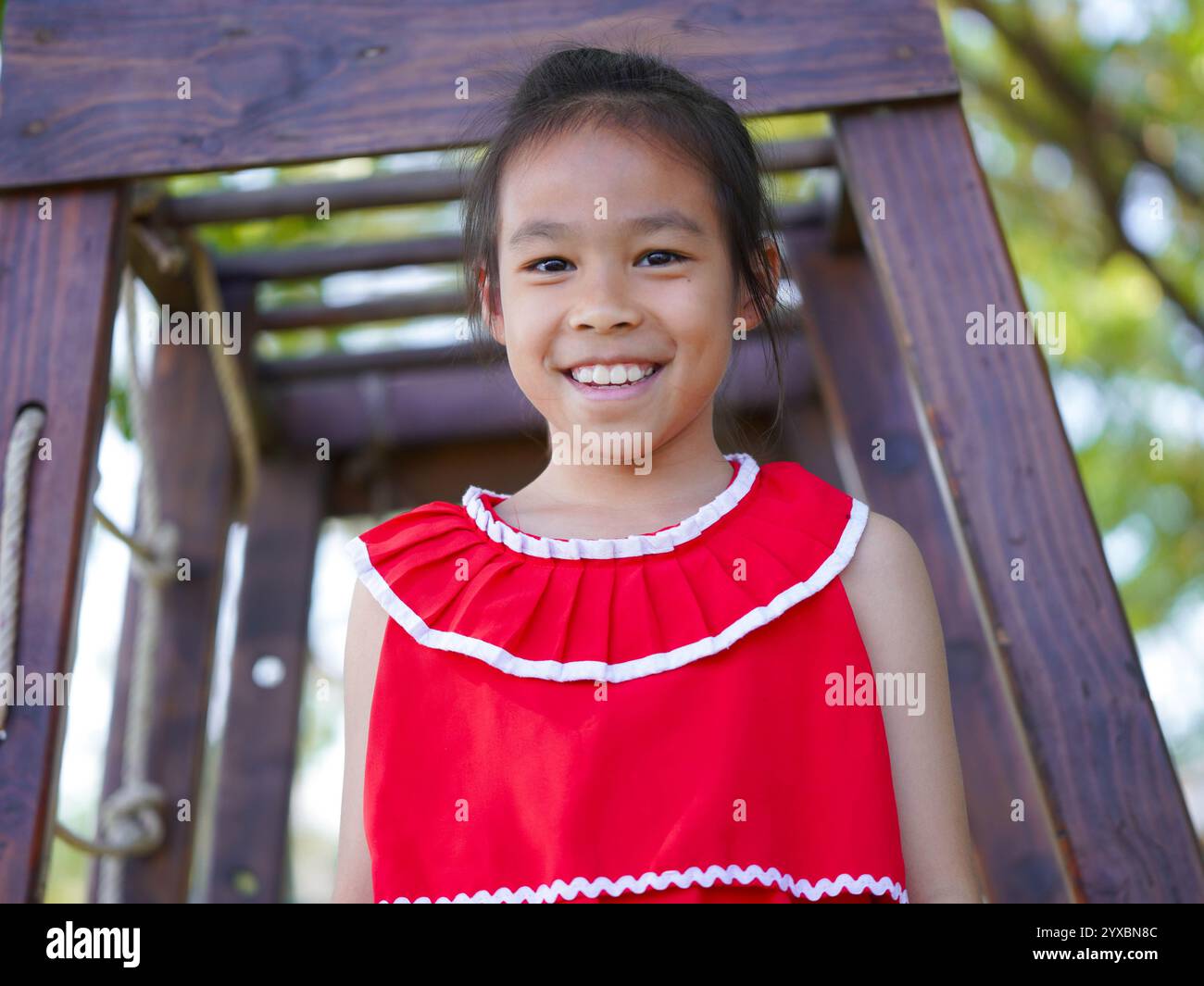 Cute girl playing in the playground during summer vacation. Happy children having fun in an ...
