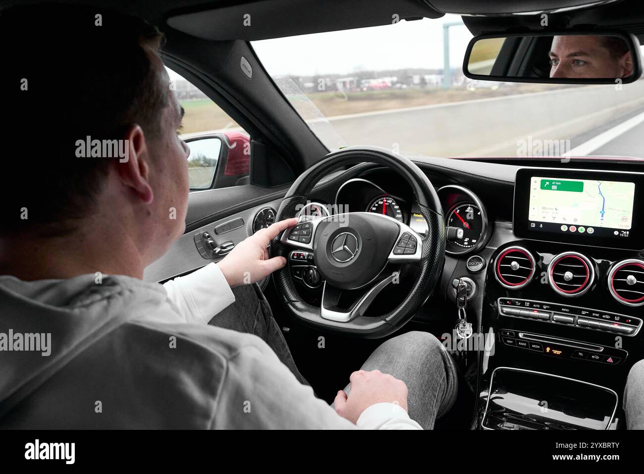 Bavaria, Germany - December 14, 2024: A young man is driving a car on ...