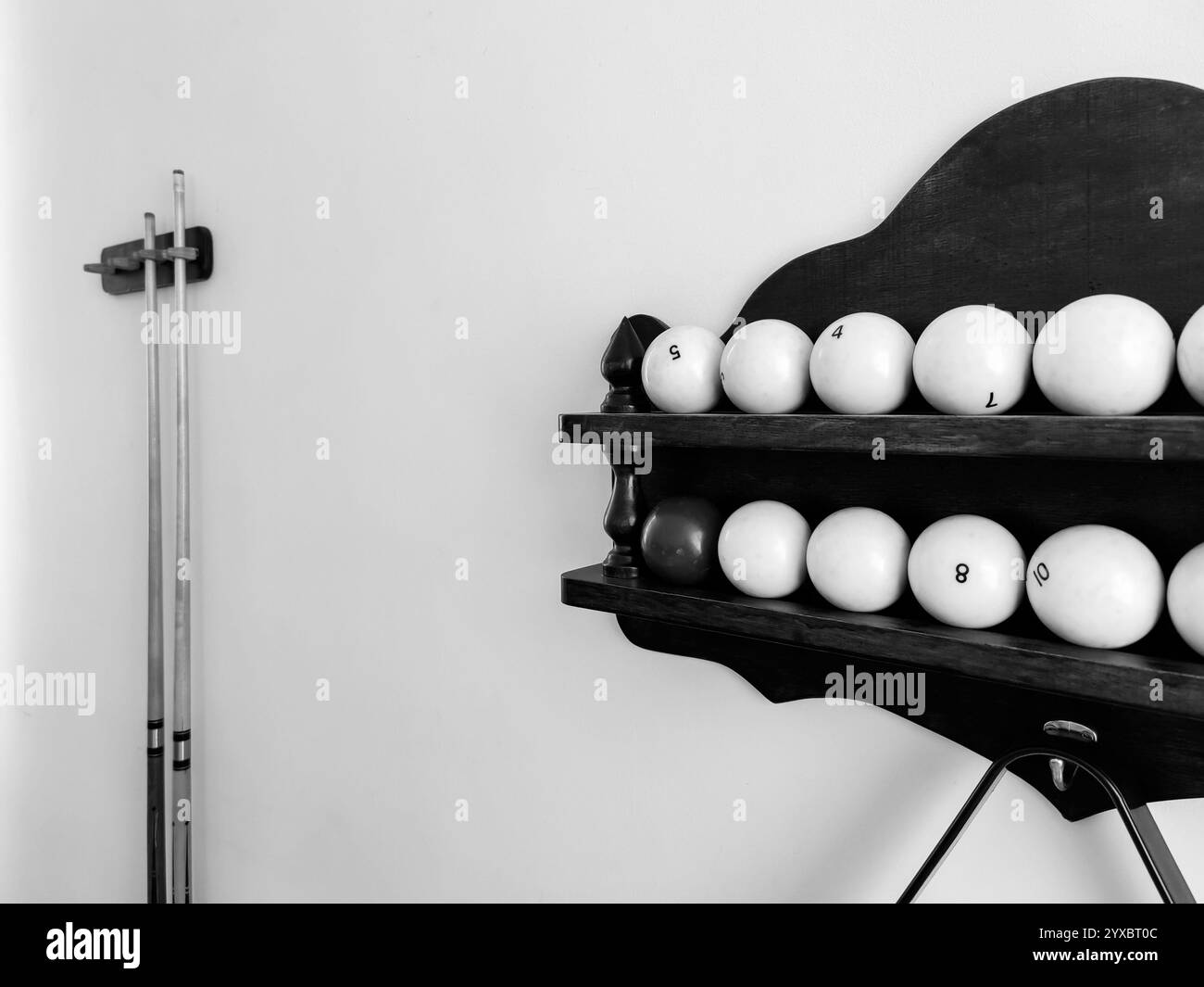 Billiard balls and triangle for pyramid are on wooden shelf attached to ...