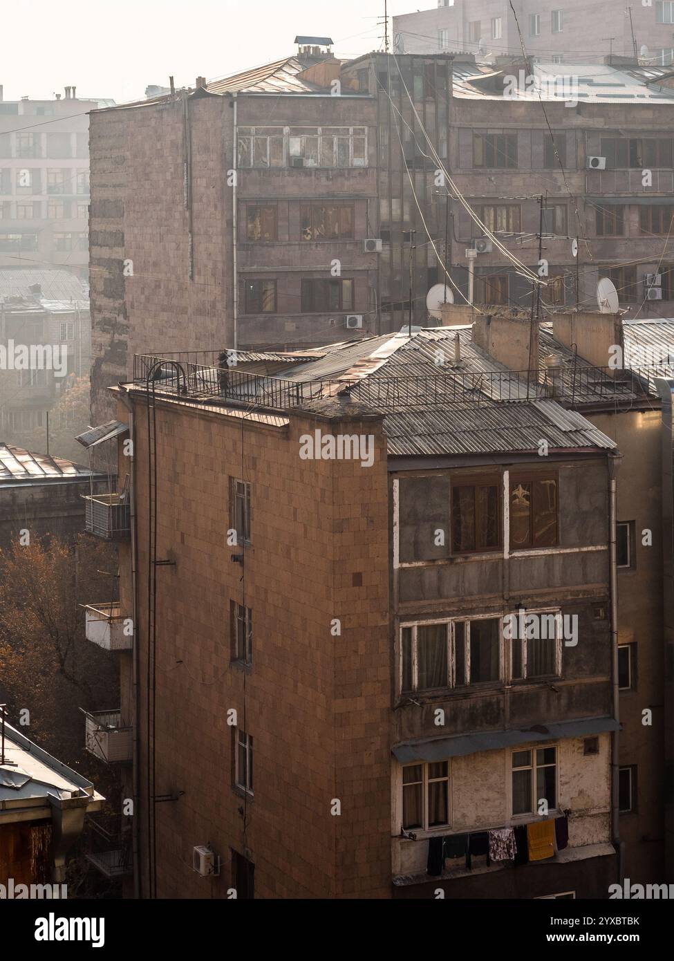 view of old apartment buildings in sunny morning with urban smog in ...