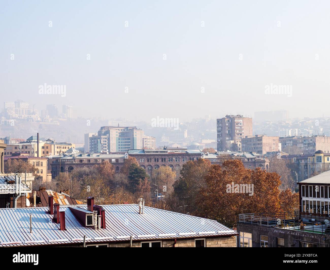 skyline of Yerevan city in sunny morning with urban smog in winter ...