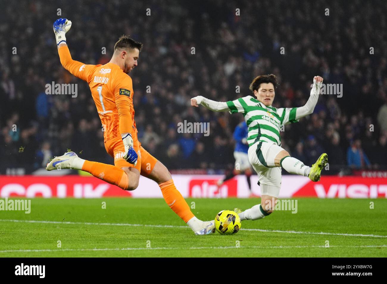 Rangers goalkeeper Jack Butland (left) clears the ball under pressure ...