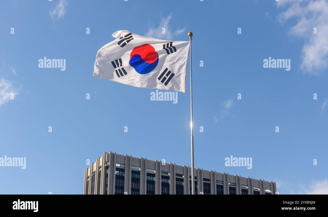 A South Korean flag is flying in the wind near the Government Complex ...