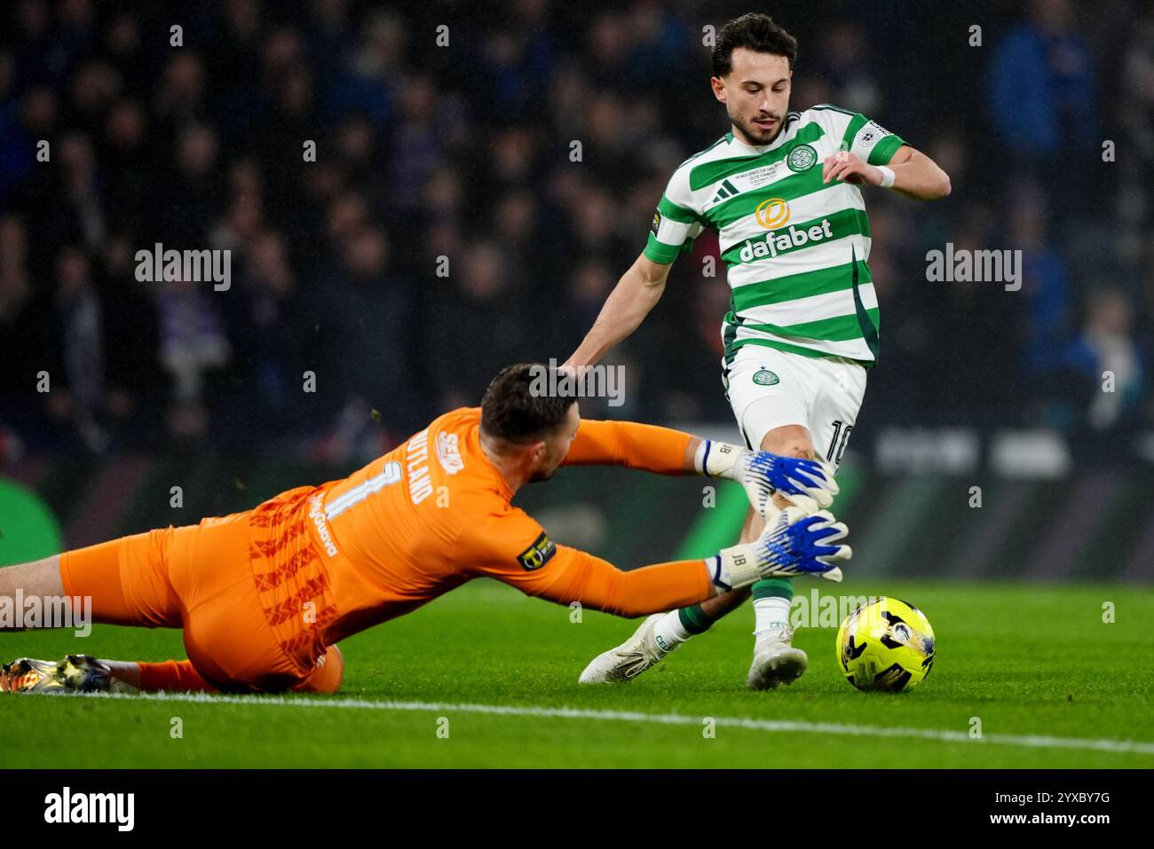 Rangers goalkeeper Jack Butland (left) saves at the feet of Celtic's ...