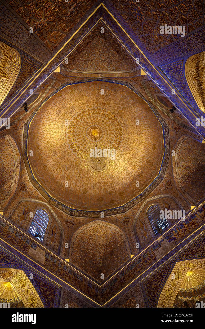 An inside view of the dome with patterns lined with gold tiles and ...