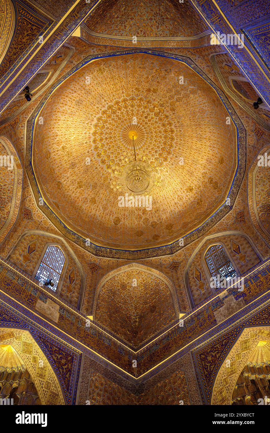 An inside view of the dome with patterns lined with gold tiles and ...