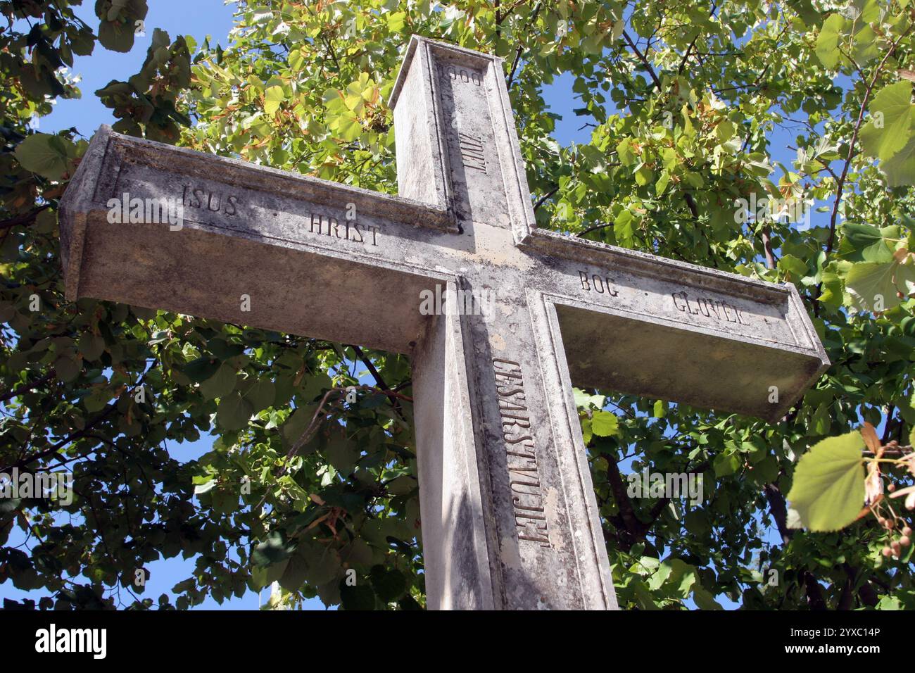 Large stone cross in front of the Church of St. Martin in Zrnovo ...