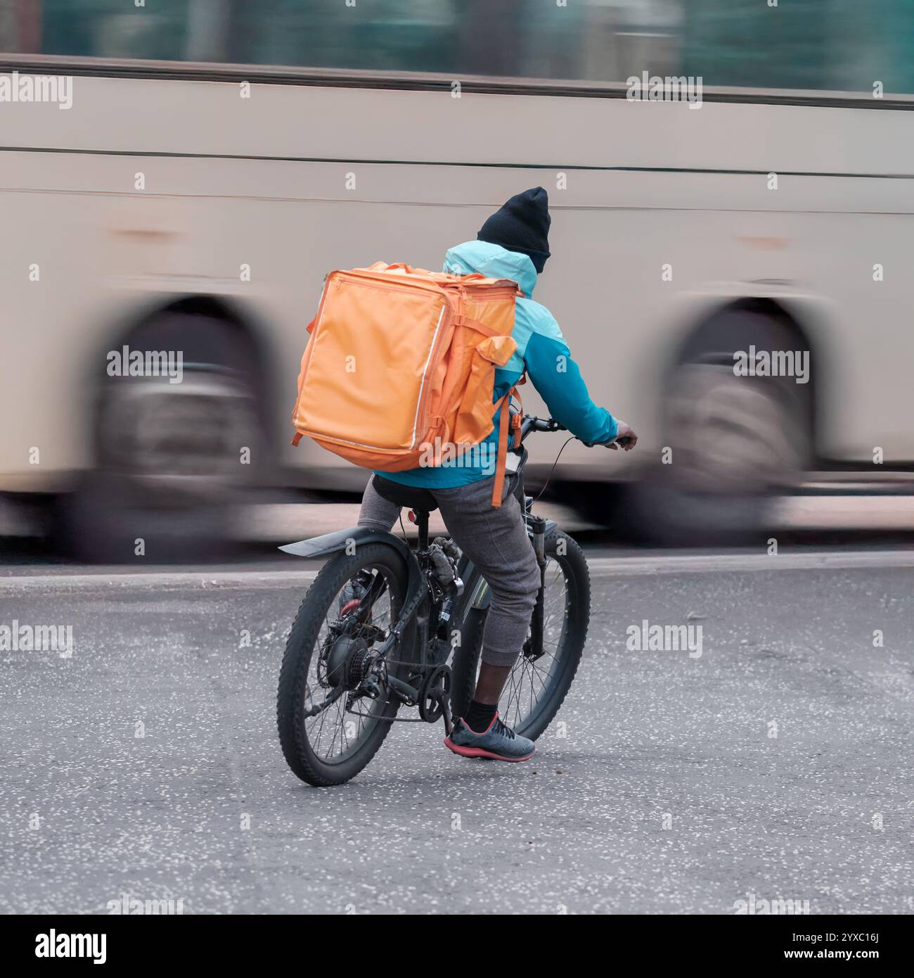 A Bicycle Fast-Food Delivery Person In Busy Traffic Stock Photo - Alamy