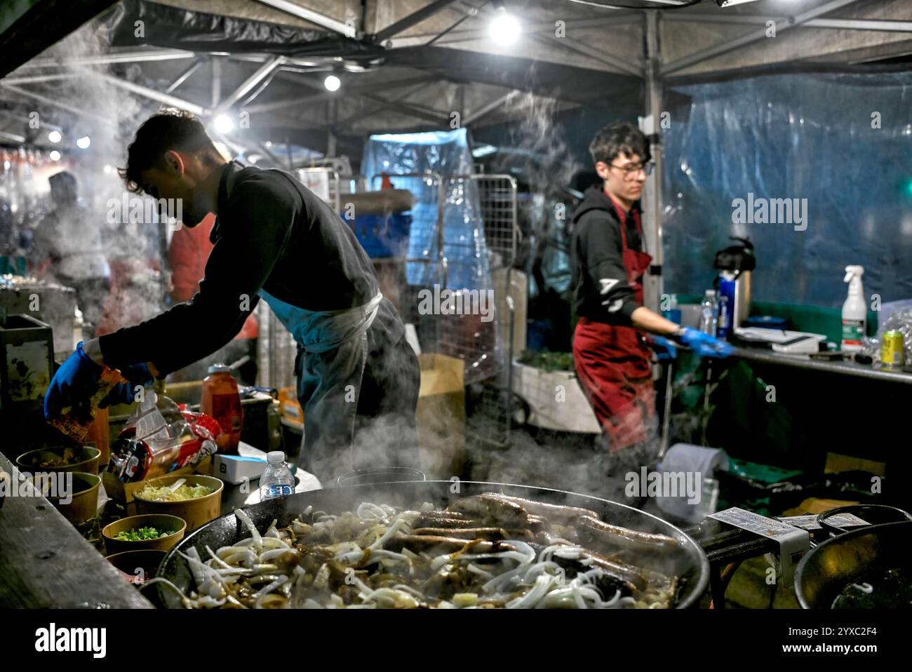 Chef cooking hot dogs and burgers at a street market, Stratford upon ...