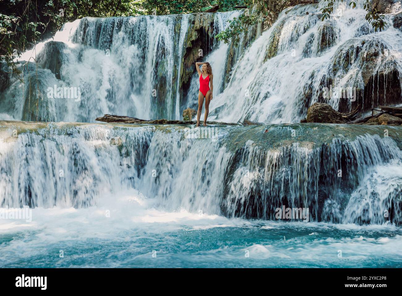 Woman on scenic cascade waterfalls with blue water in Luwuk, Central Sulawesi Stock Photo - Alamy