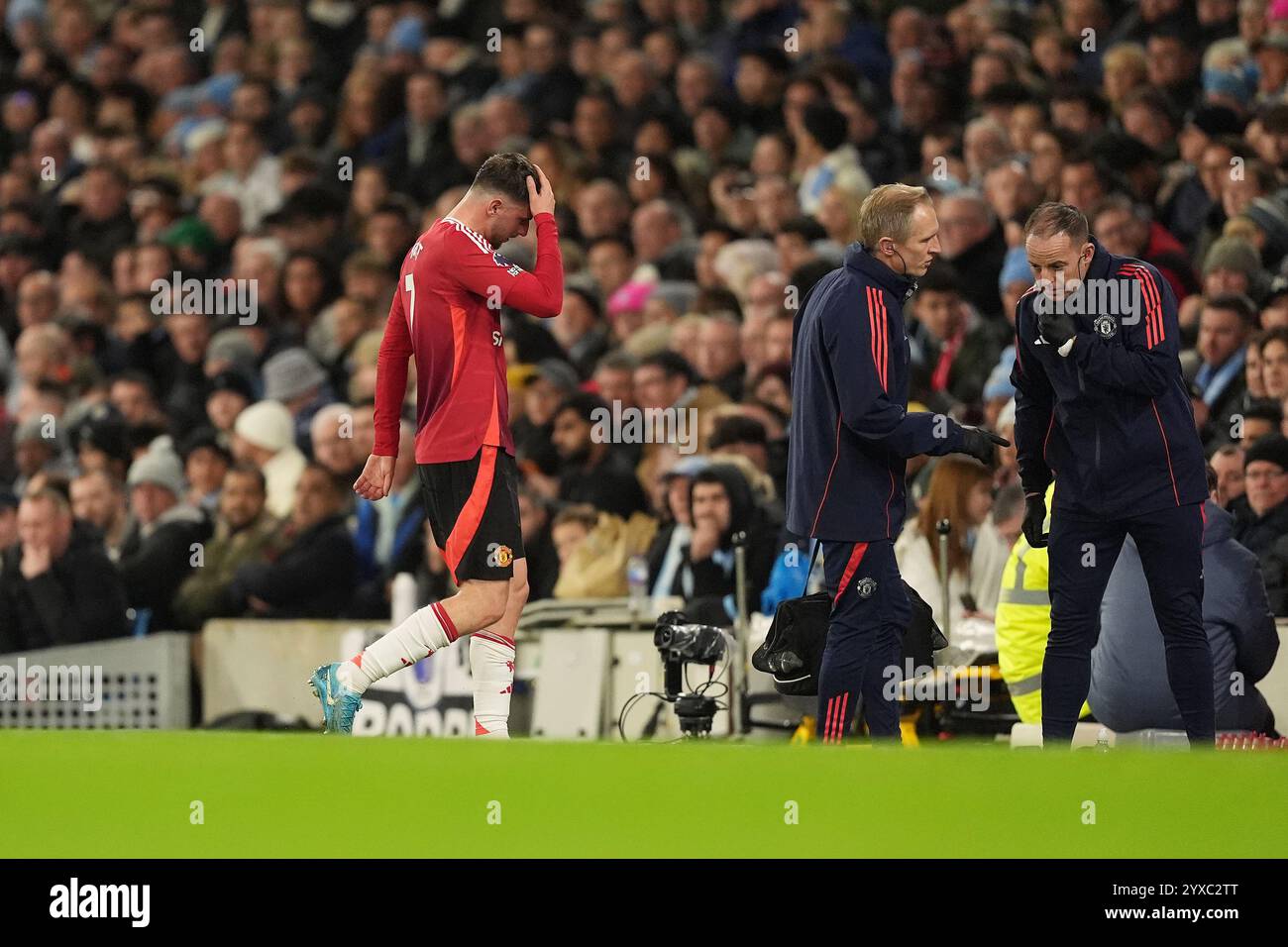 Manchester United's Mason Mount leaves the pitch after going down ...