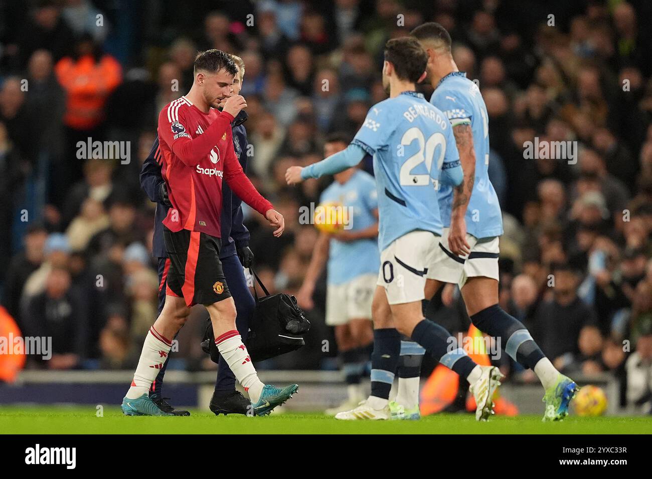 Manchester United's Mason Mount (left) leaves the pitch after going ...
