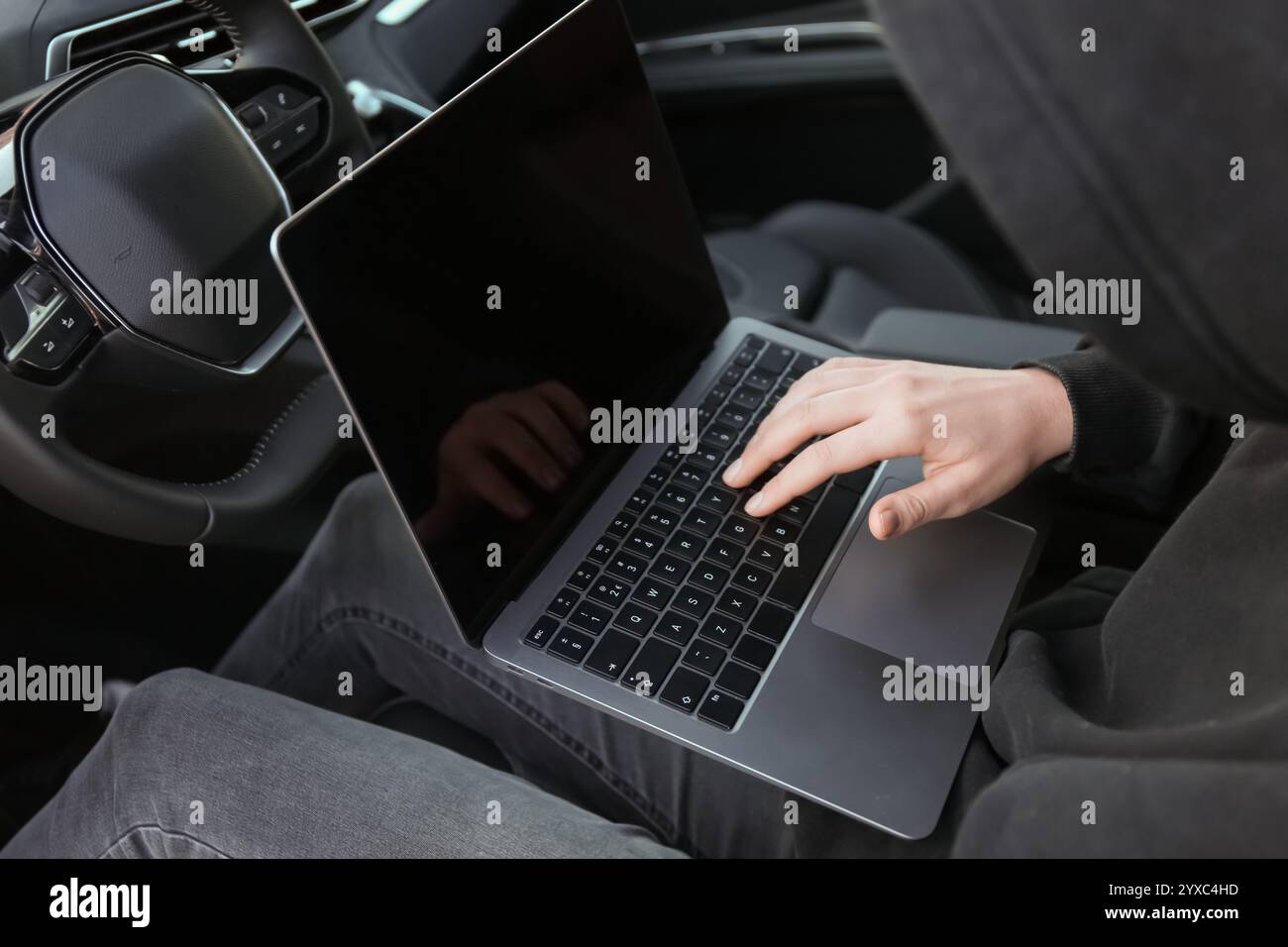 Thief hacking car system with laptop inside vehicle, closeup Stock ...