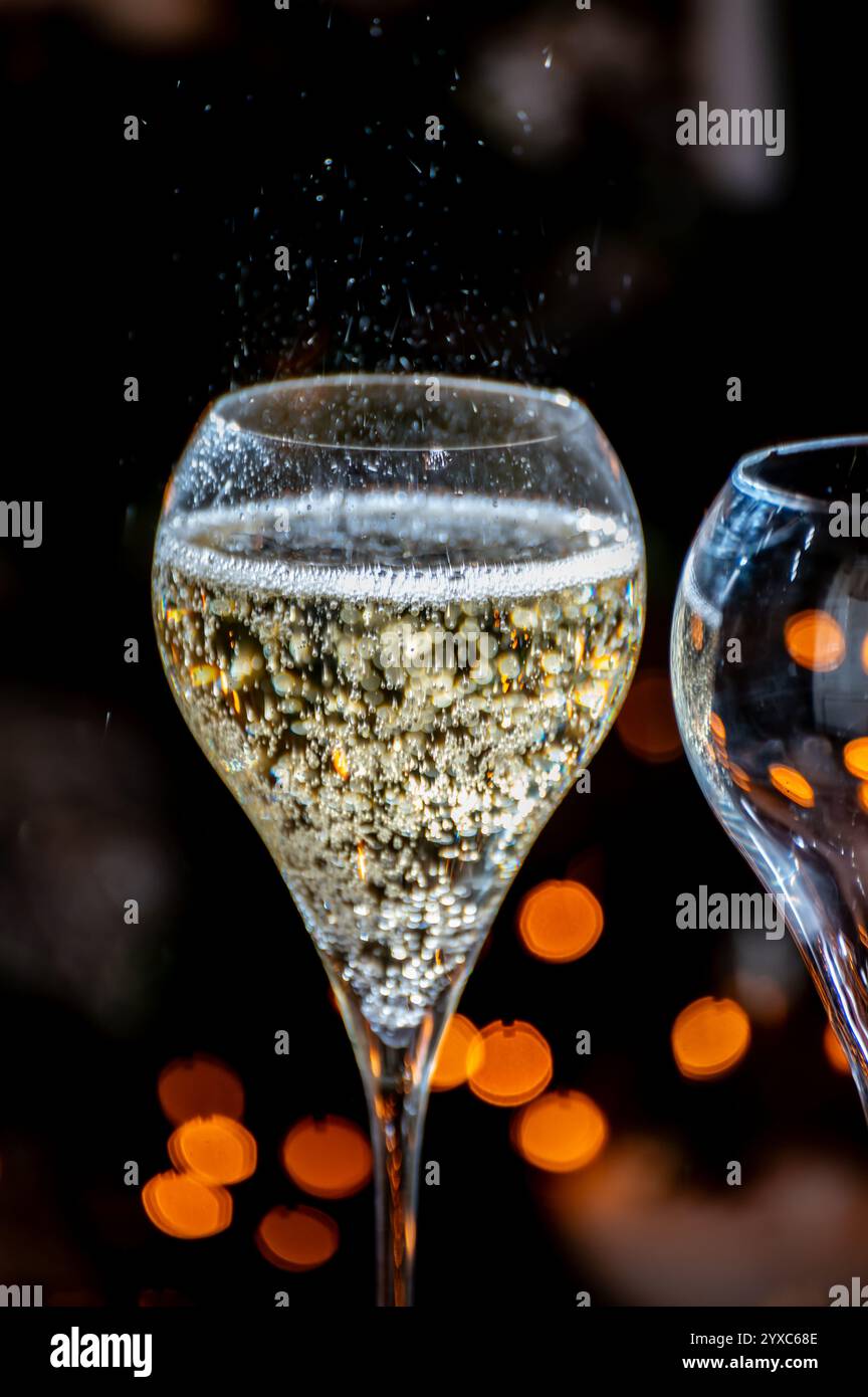 New year or christmas dinner, pouring of glass of brut champagne or ...