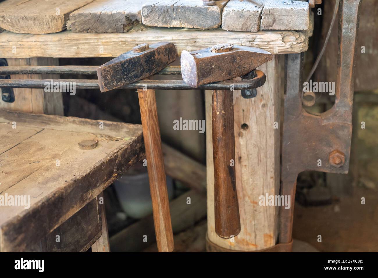 Blacksmith hammers on a wooden workbench in an old workshop Stock Photo ...