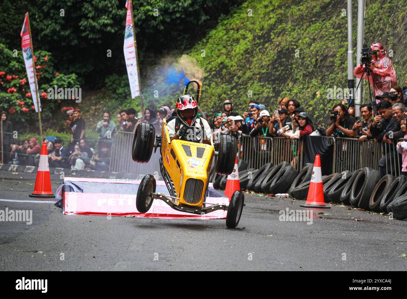 Participants clear the last jump at the Soap Box Derby in Bandung, West ...