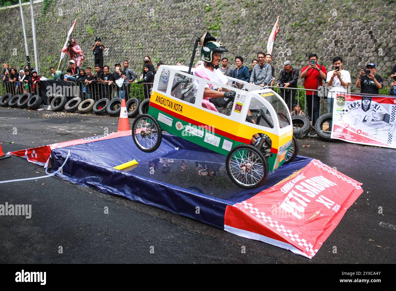 Participants clear the last jump at the Soap Box Derby in Bandung, West ...