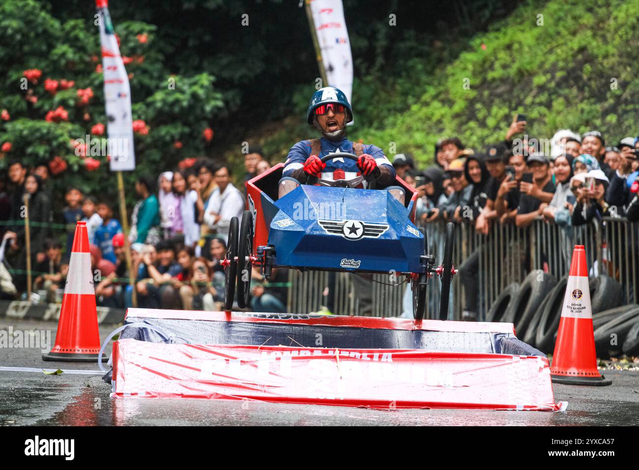 Participants clear the last jump at the Soap Box Derby in Bandung, West ...