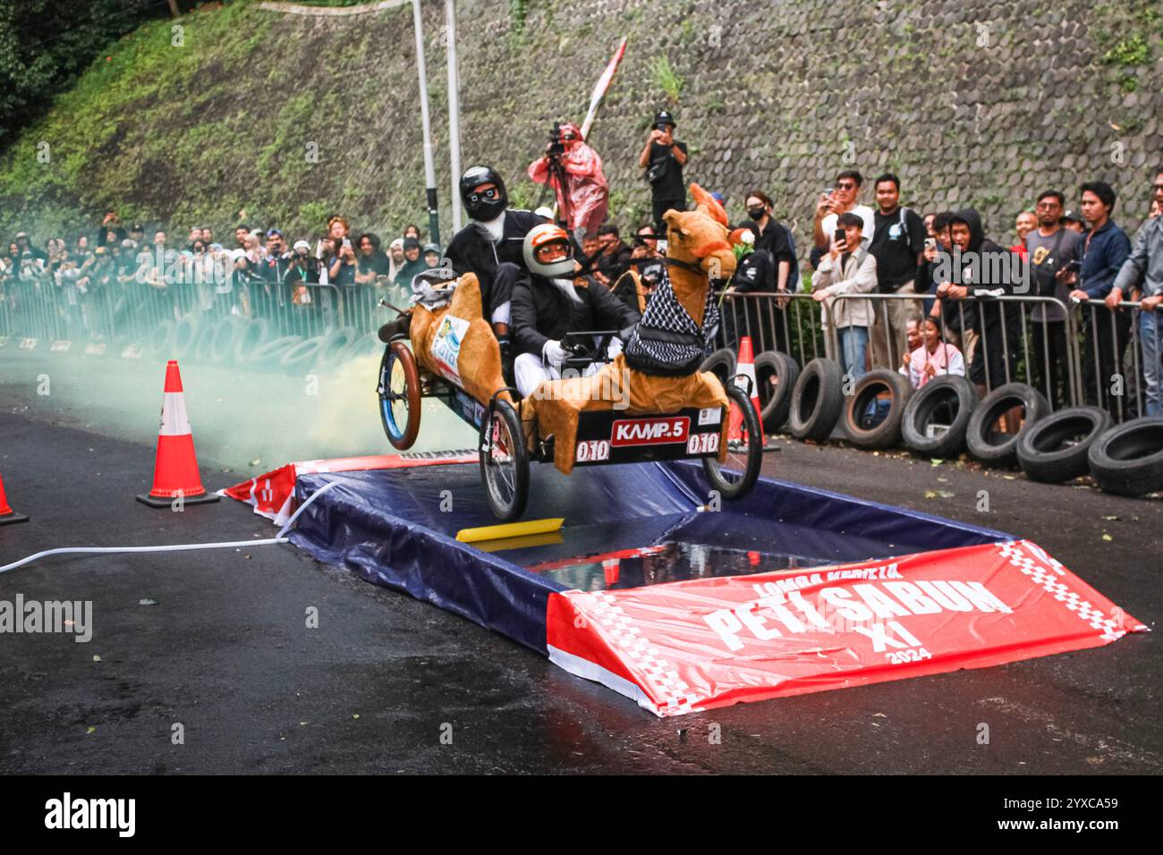 Participants clear the last jump at the Soap Box Derby in Bandung, West ...
