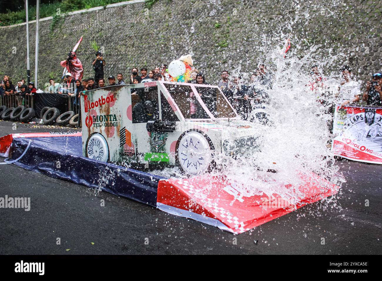 Participants clear the last jump at the Soap Box Derby in Bandung, West ...